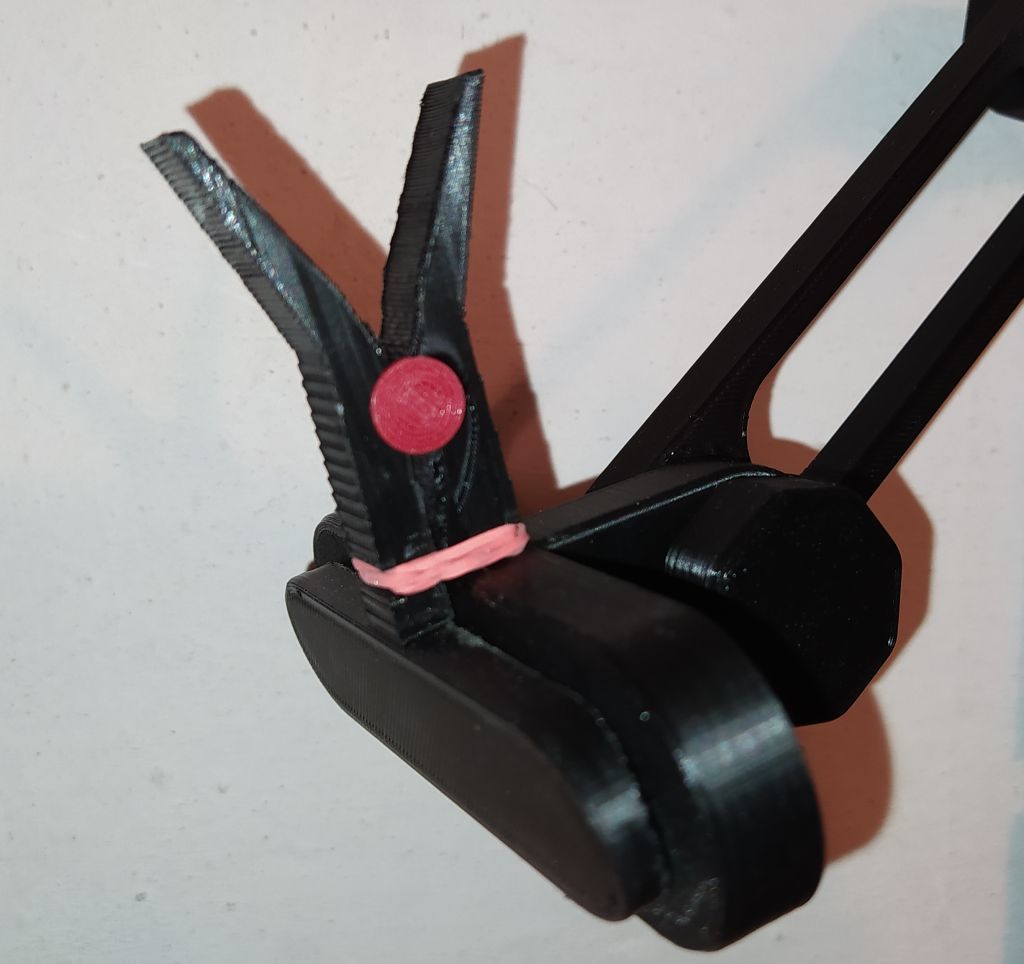 Paper holder spring clamp attachment to articulated lamp system by ...