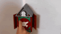 A WALL CLOCK WITH HIDDEN DOORS AND A BIRD COMING OUT par ilan kaplan ...