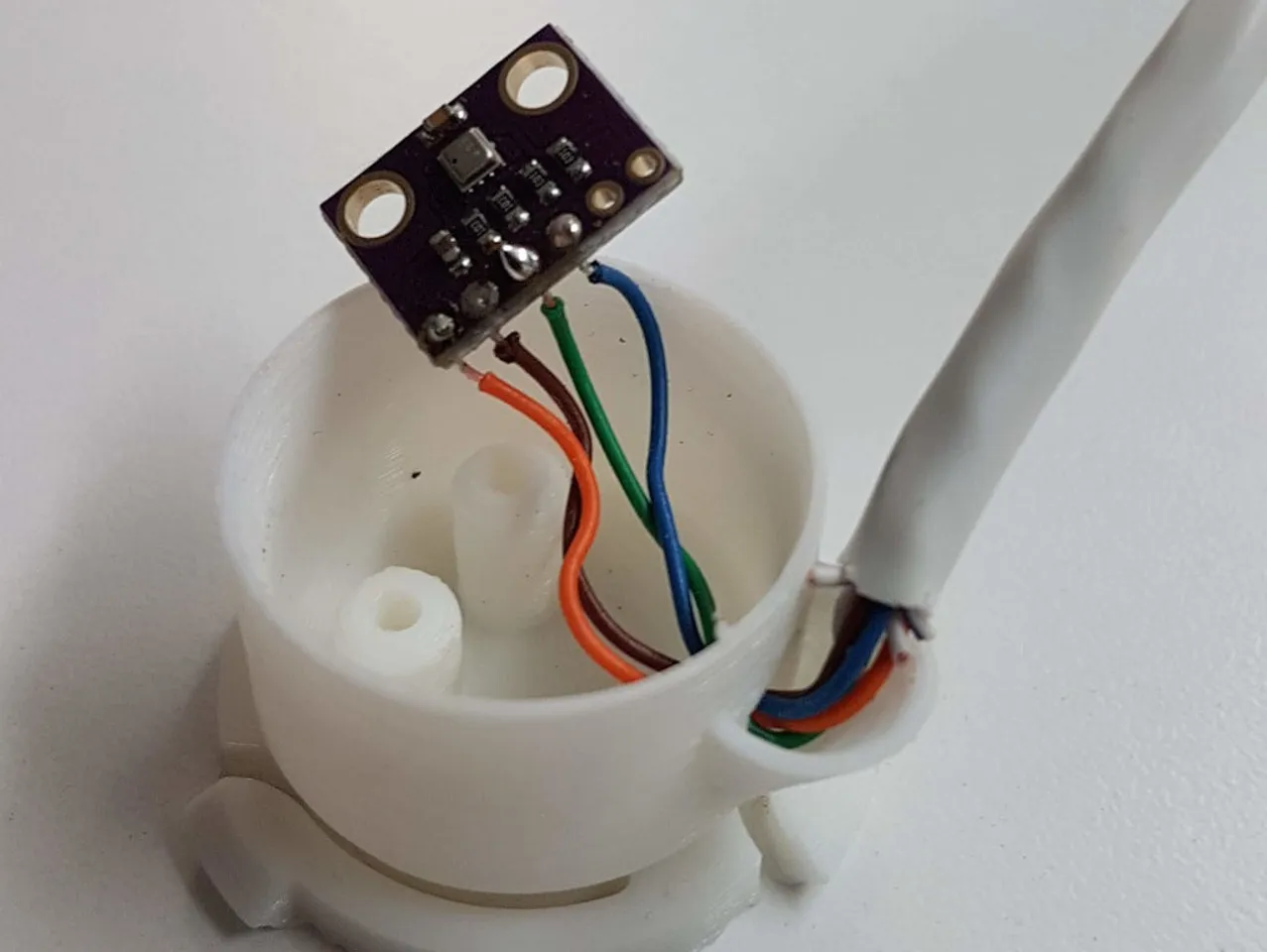 Helical rain/radiation shield for weather sensors with sensor mounting ...