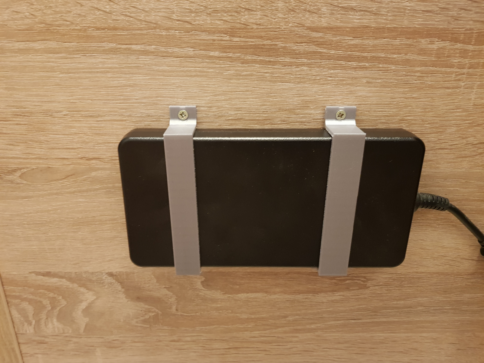 Parametrizable power adapter holder with optional engraved/protruded ...
